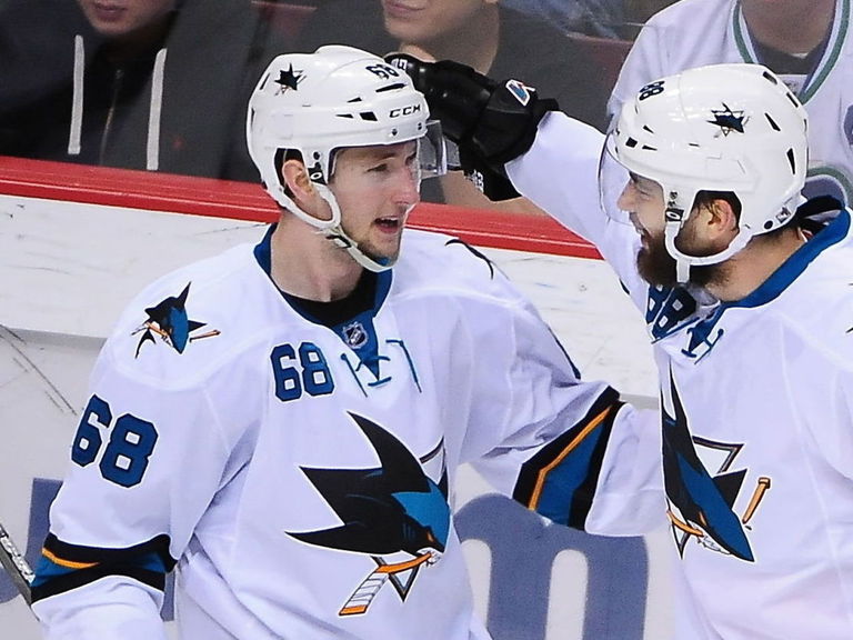 VIDEO: Sharks' Karlsson scores while lying on ice | theScore.com