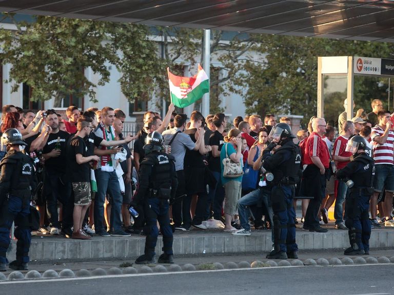 VIDEO: Hungarian football hooligans pelt refugees with smoke bombs ...