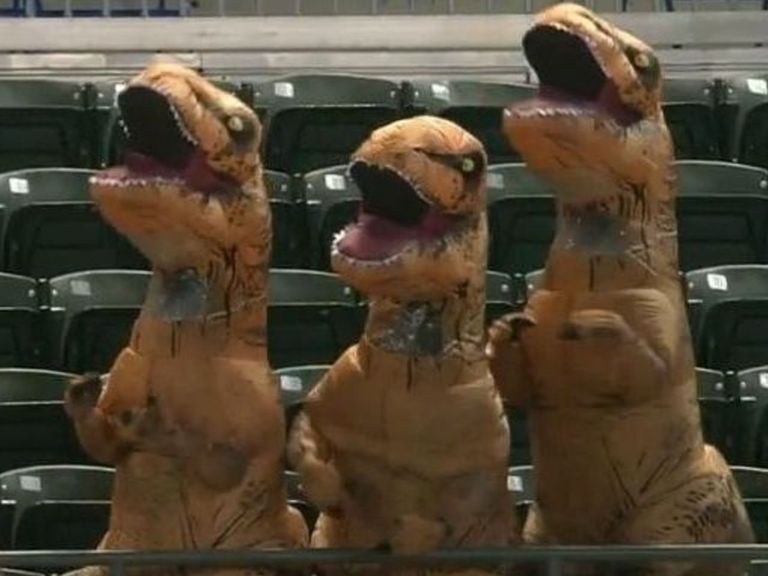 Watch: Dancing dinosaurs invade Oakland Coliseum | theScore.com