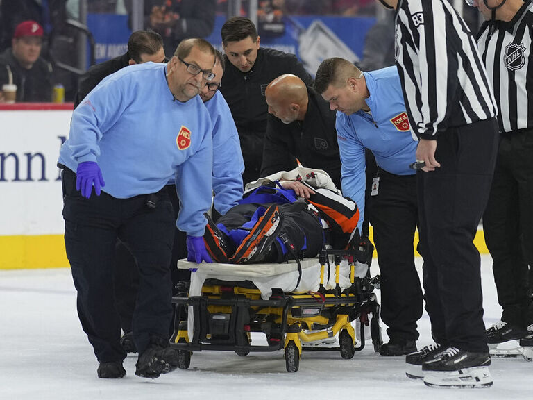 Referee Dunning stretchered off after collision with Avalanche's Manson ...